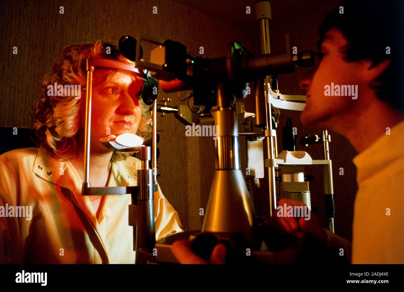 Optician using a keratometer to measure the radius of curvature of the ...