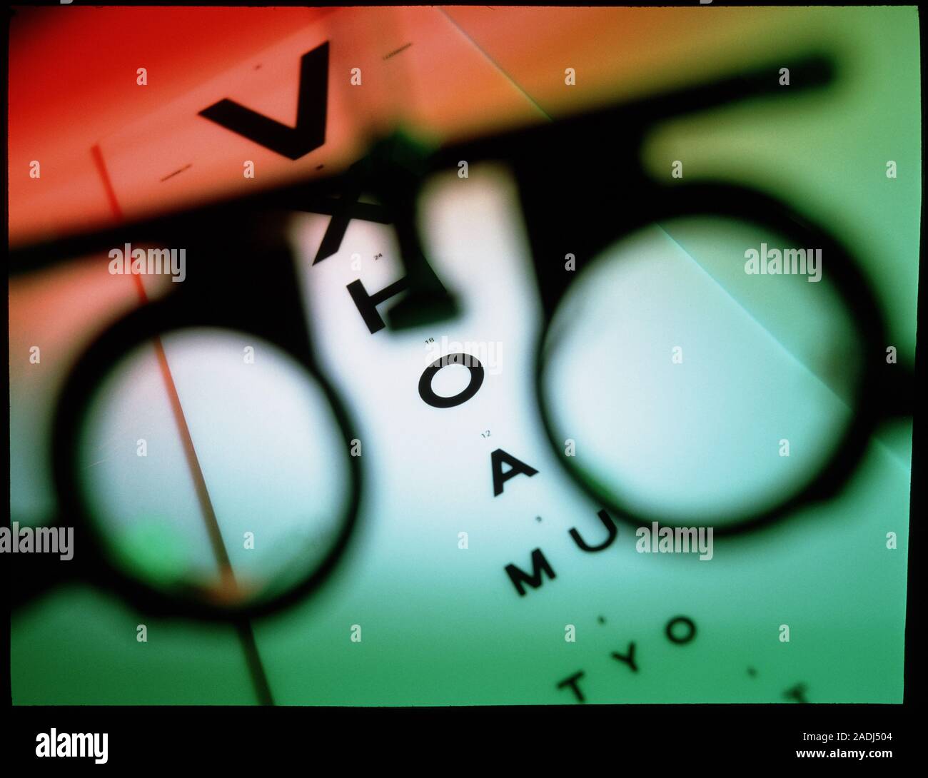 Eye test chart and frames. Ophthalmology test wall chart seen through a ...