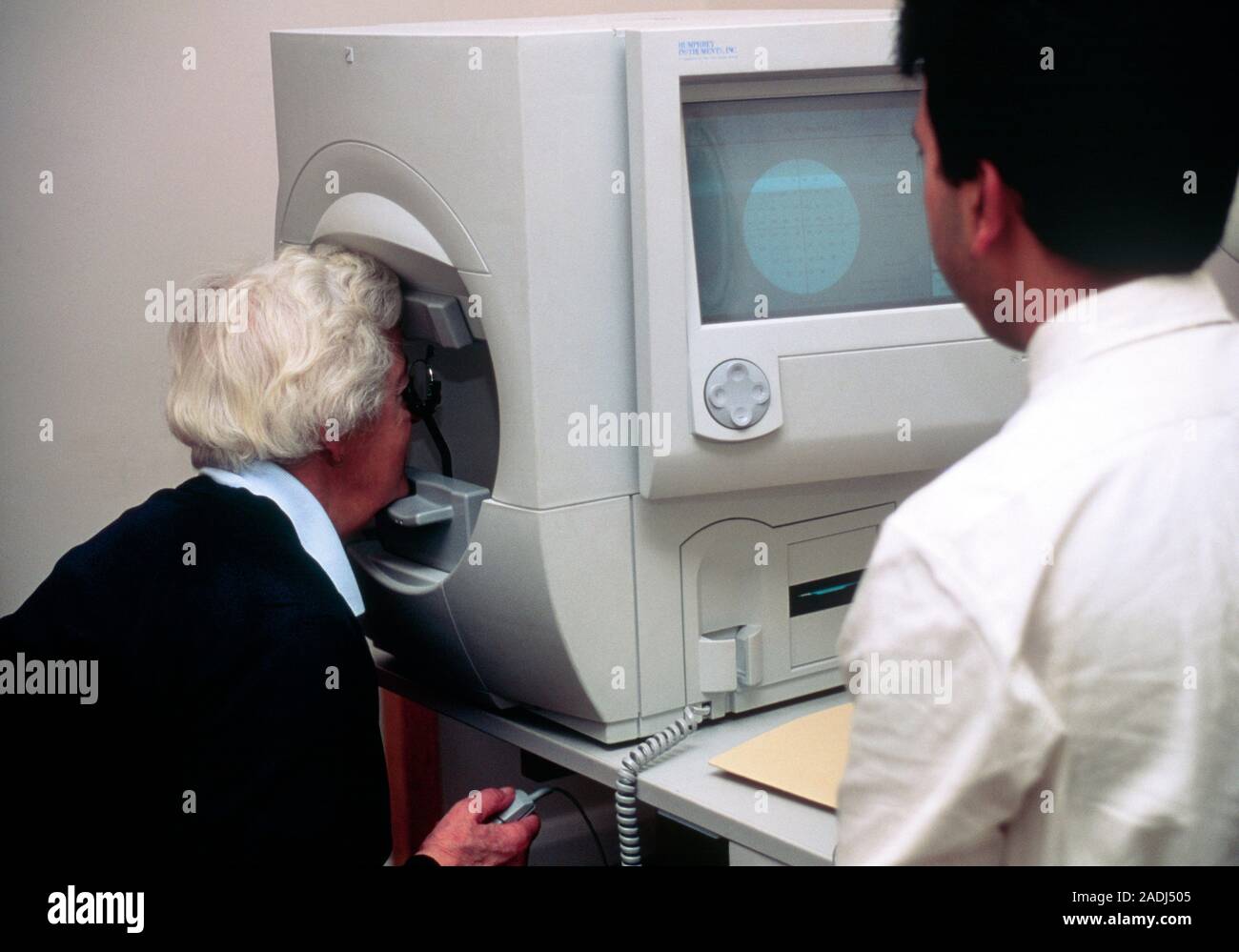 Visual field test. Elderly patient undergoing a visual field test. She ...