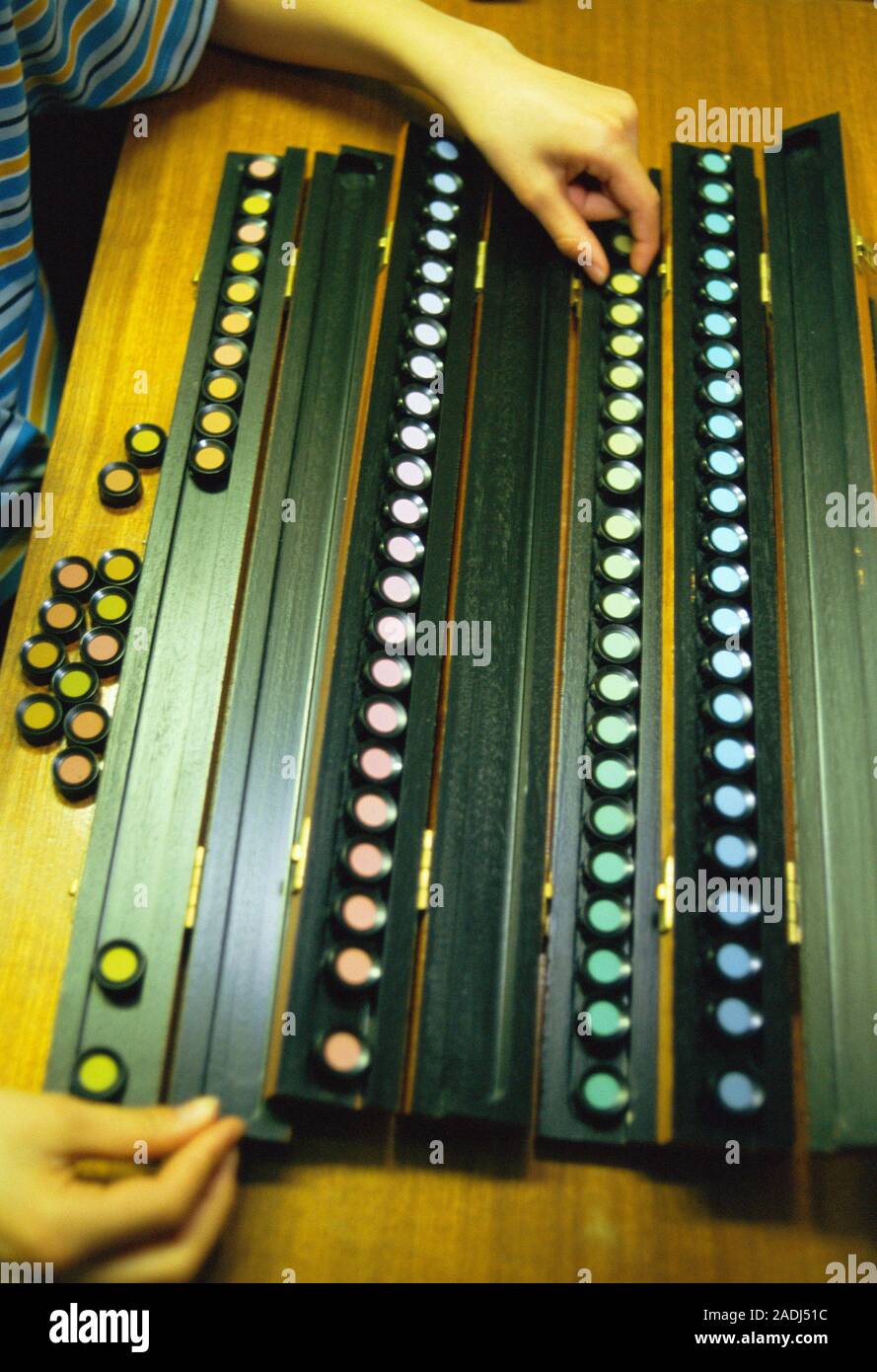 Colour blindness test. Caps of different colours, representing the hue ...