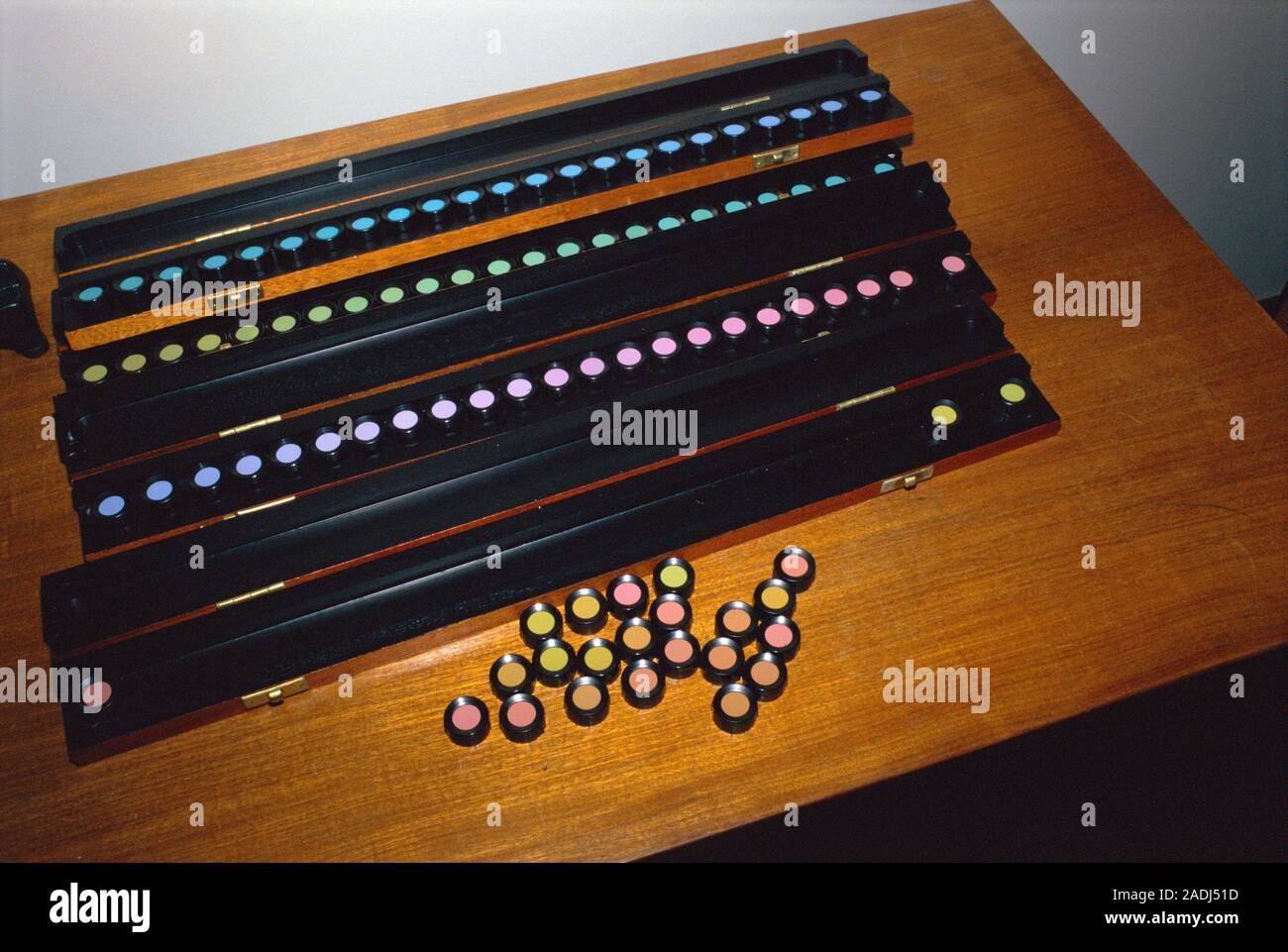 Colour blindness test. Caps of different colours, representing the hue ...