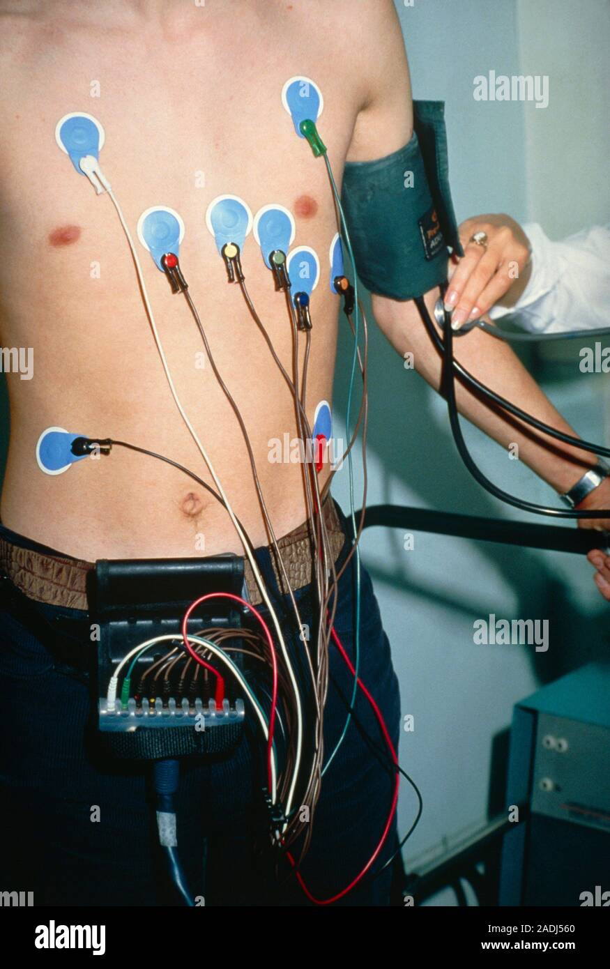 Patient wired to an electrocardiograph (ECG) machine for measuring the ...
