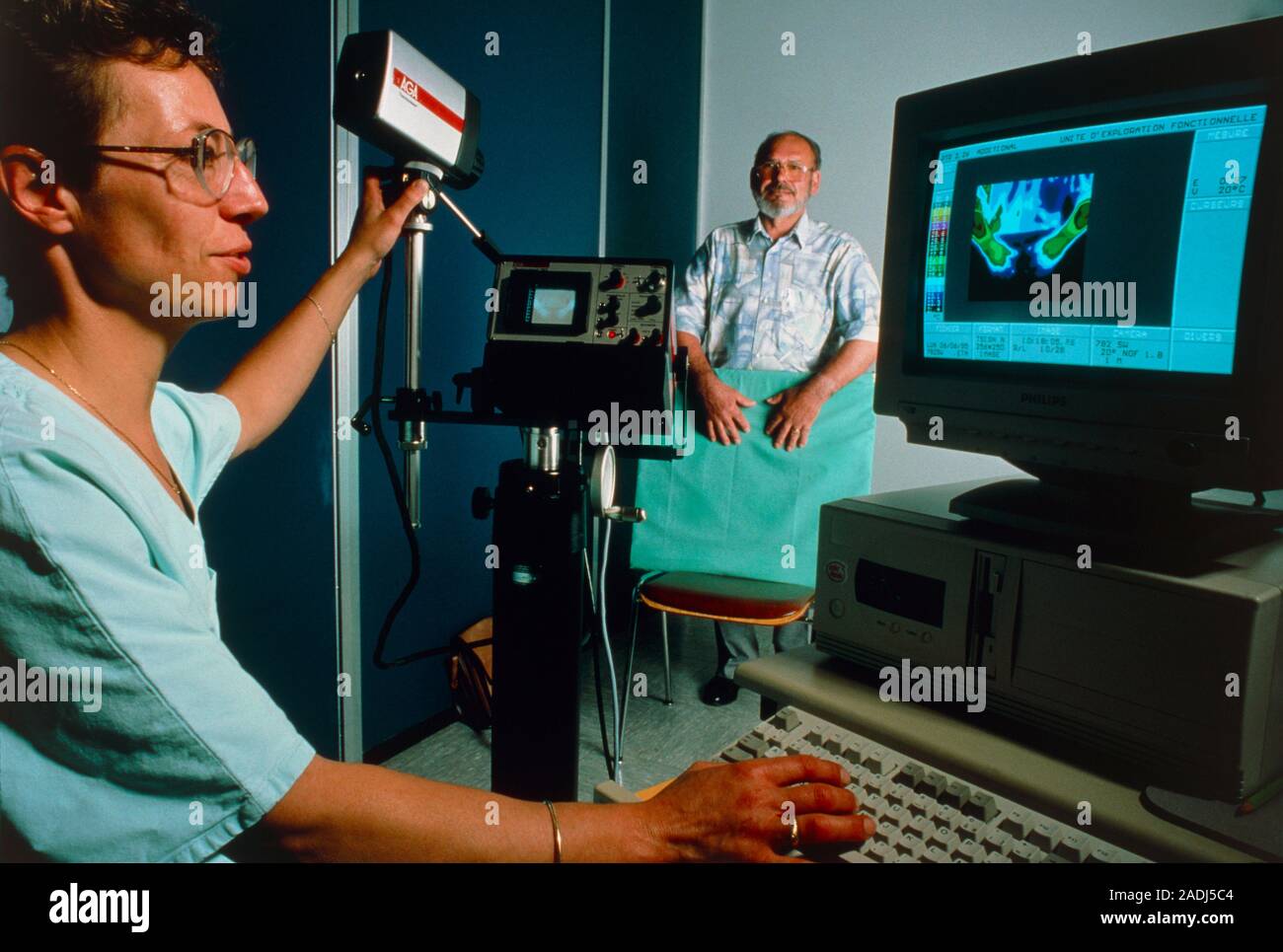 Thermography camera in use. Technician aims a thermovision camera at a ...