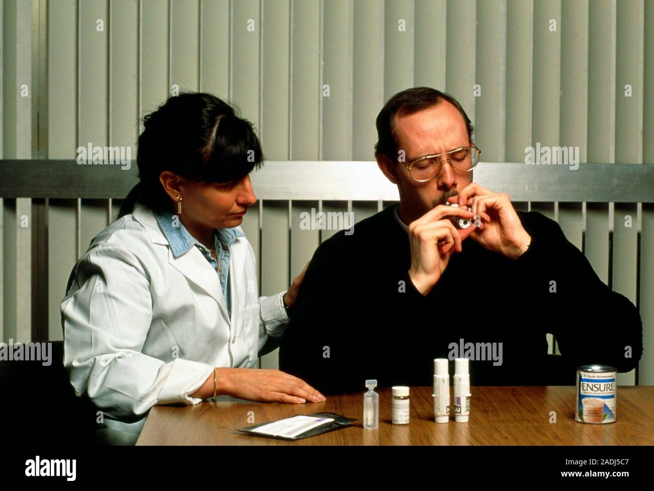 Breath test for stomach ulcer. A doctor watches as a patient blows into ...