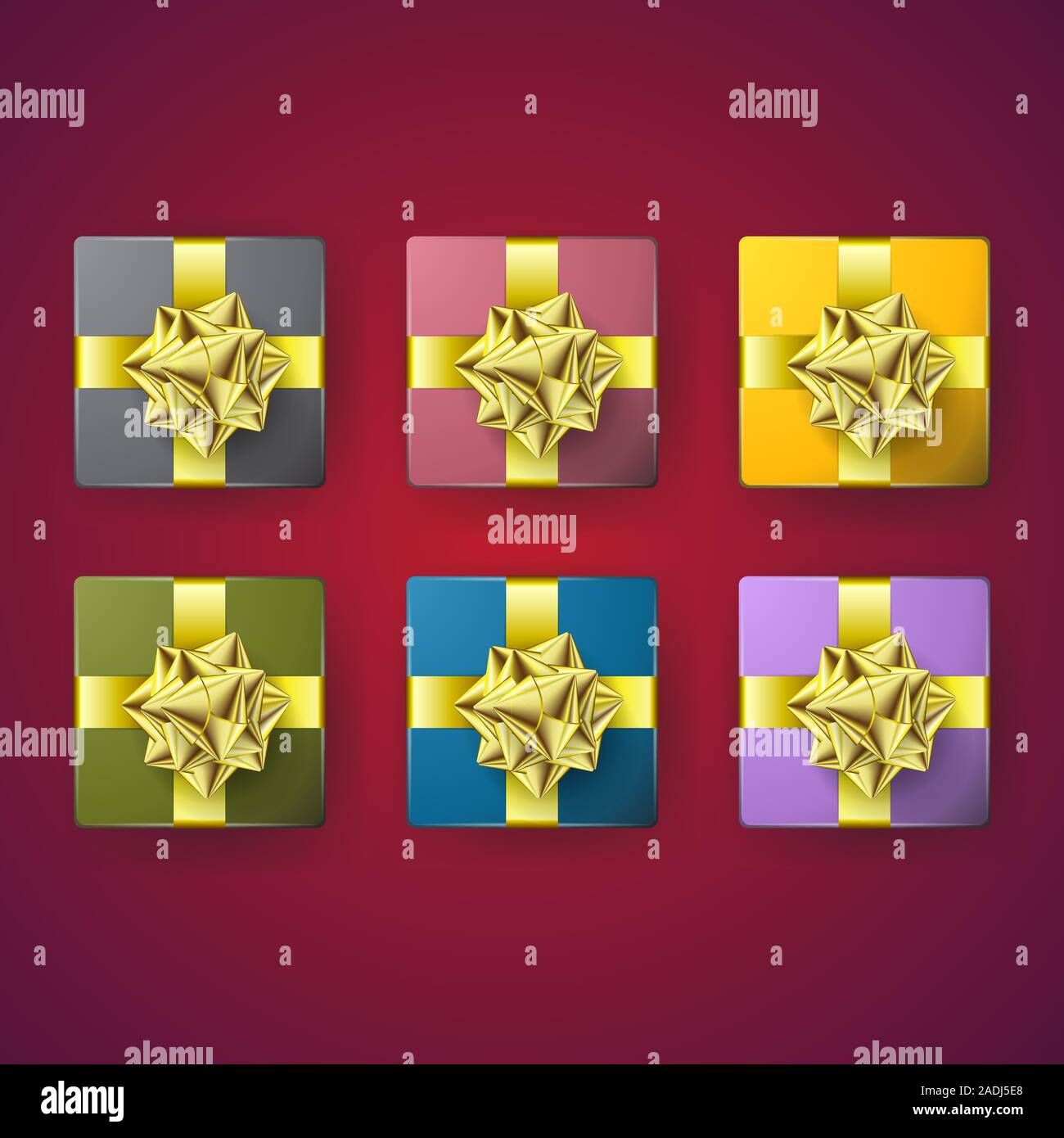 Set of multi-colored gift boxes with a gold bow on the insulated layer ...