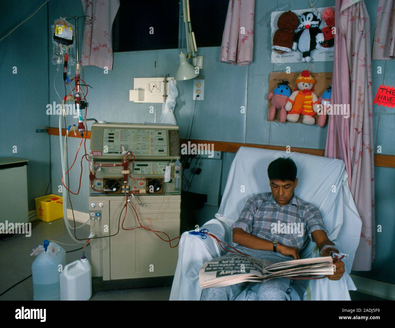 Male patient using a kidney machine to undergo renal dialysis. A kidney ...