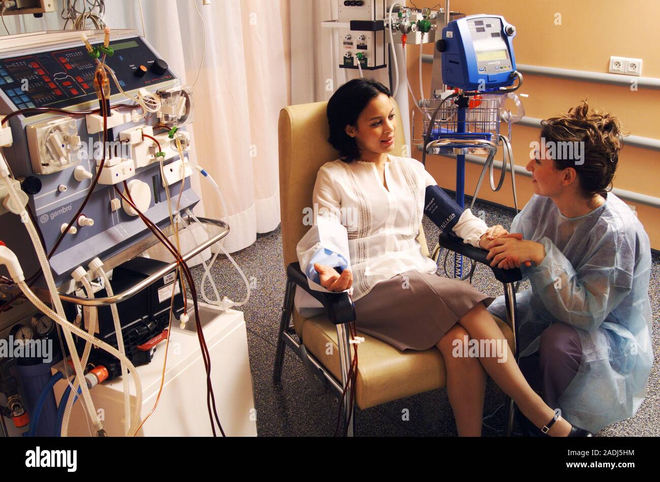 Kidney dialysis. Nurse reassuring a patient before starting renal ...
