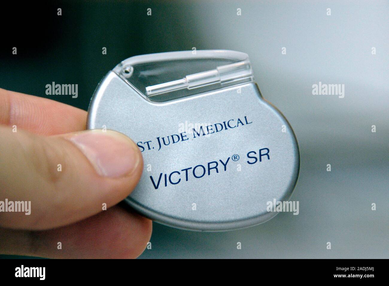 Heart pacemaker held in a hand. A pacemaker is a device that supplies ...