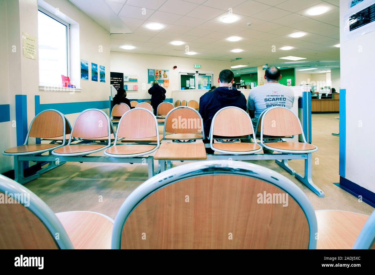 MODEL RELEASED. Hospital waiting room. Patients waiting in the accident ...