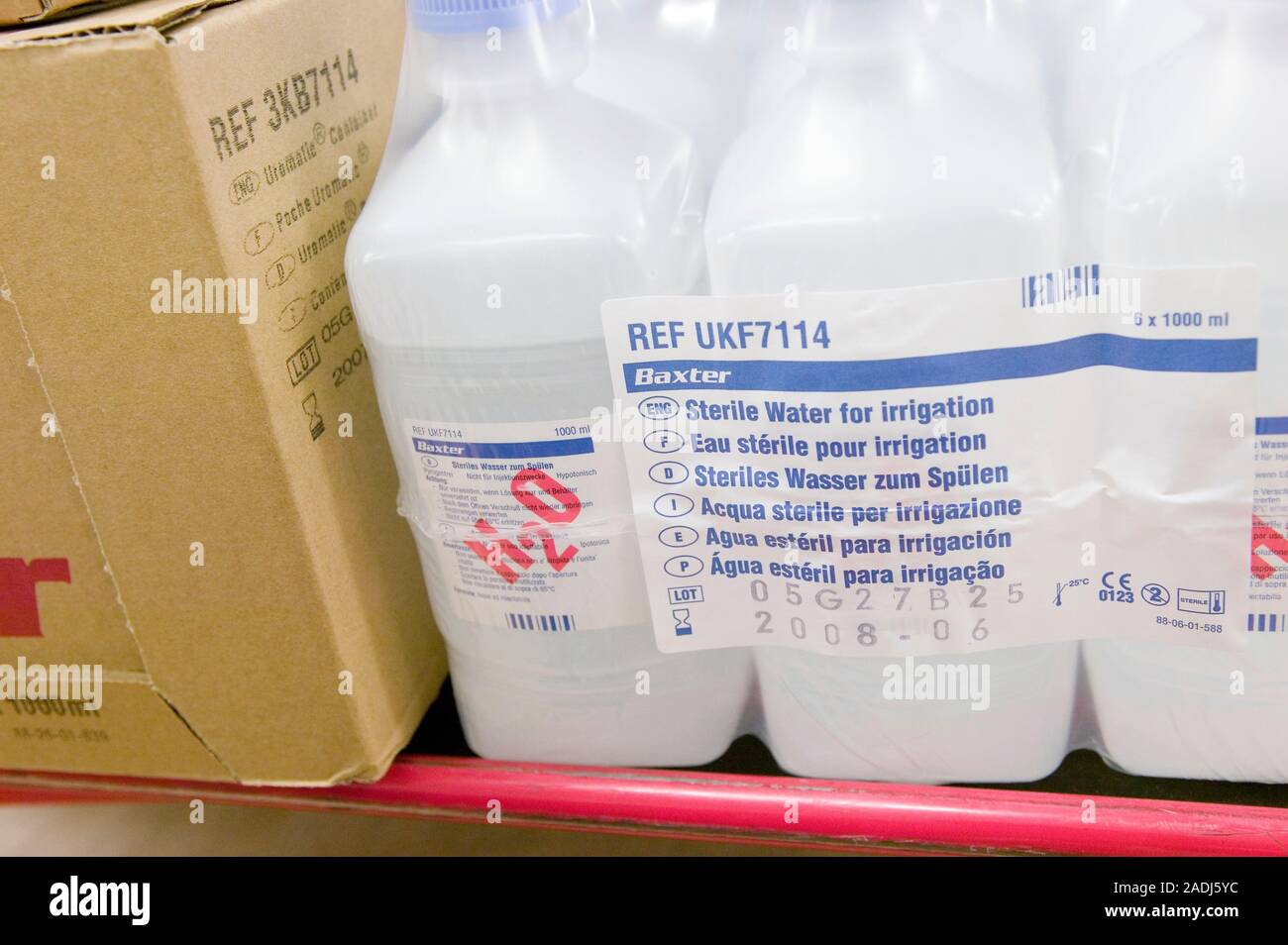 Medical supplies. Bottles of sterile water on a trolley in a hospital ...