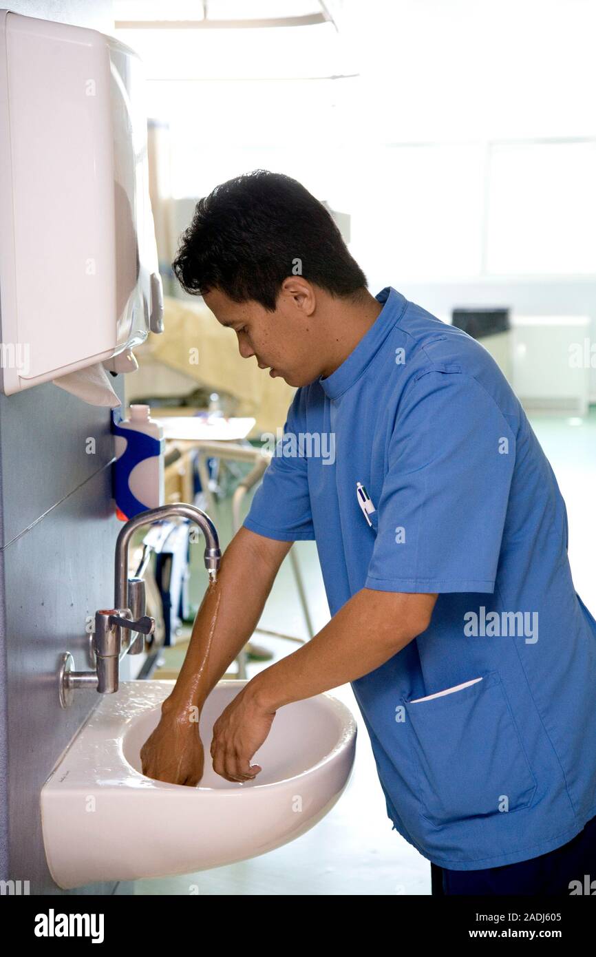 MODEL RELEASED. Hospital hygiene. Hospital staff member washing his ...