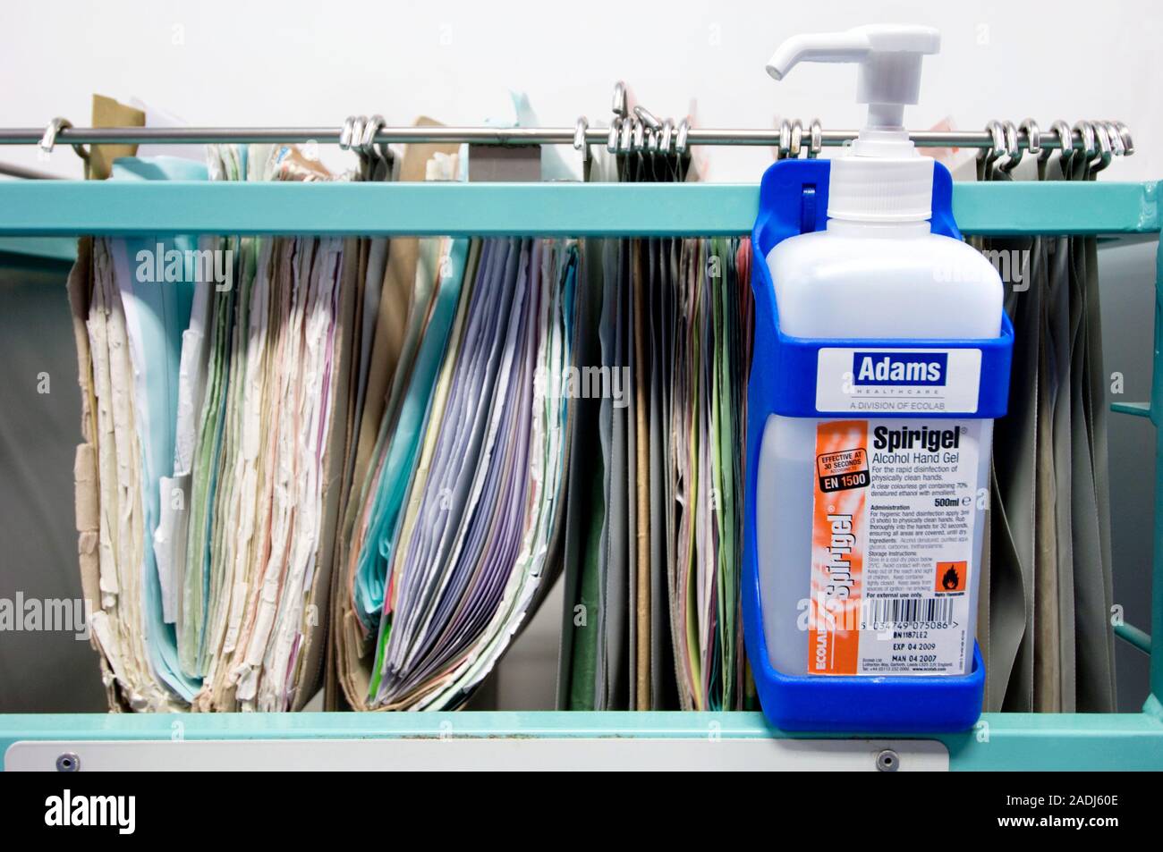 Hospital hygiene. Alcohol hand gel dispenser on a filing cabinet ...