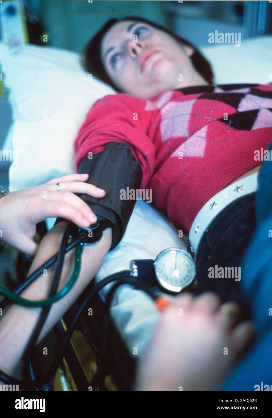 Ambulance treatment. Paramedic taking the blood pressure of a patient ...