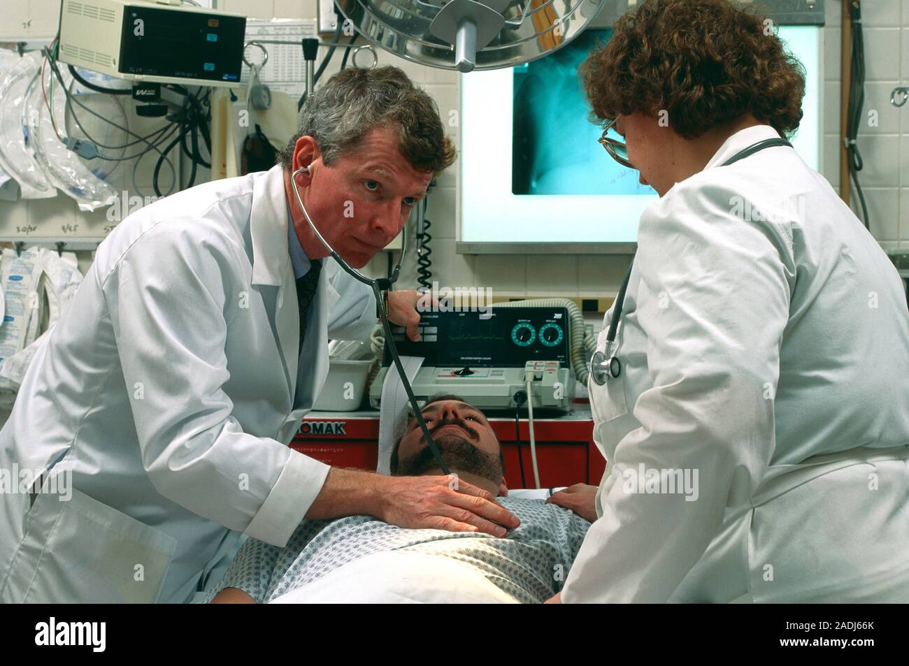 Emergency treatment. Male patient is given emergency coronary care by a ...