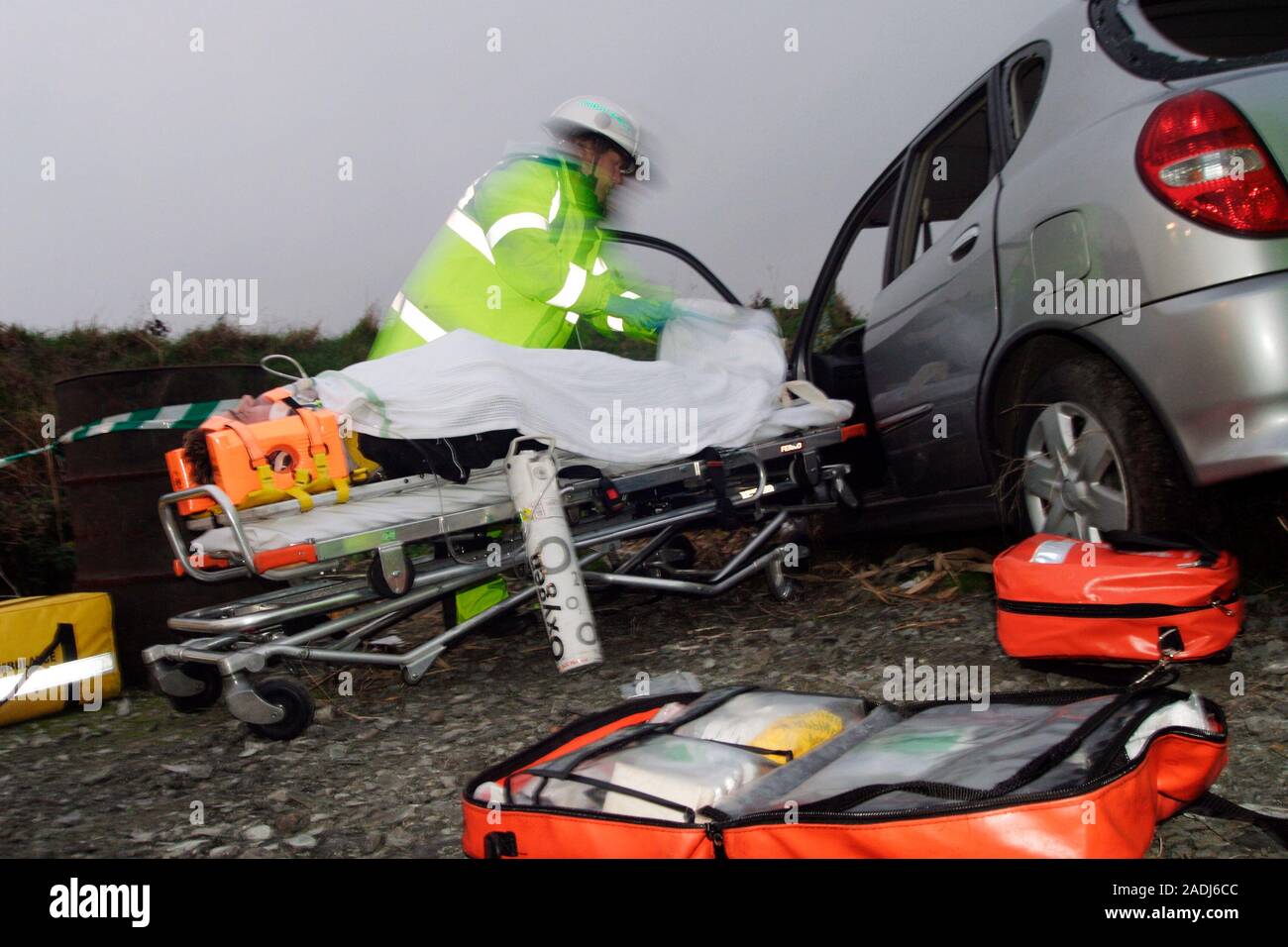 Emergency treatment. Paramedic treating a man with a suspected neck ...