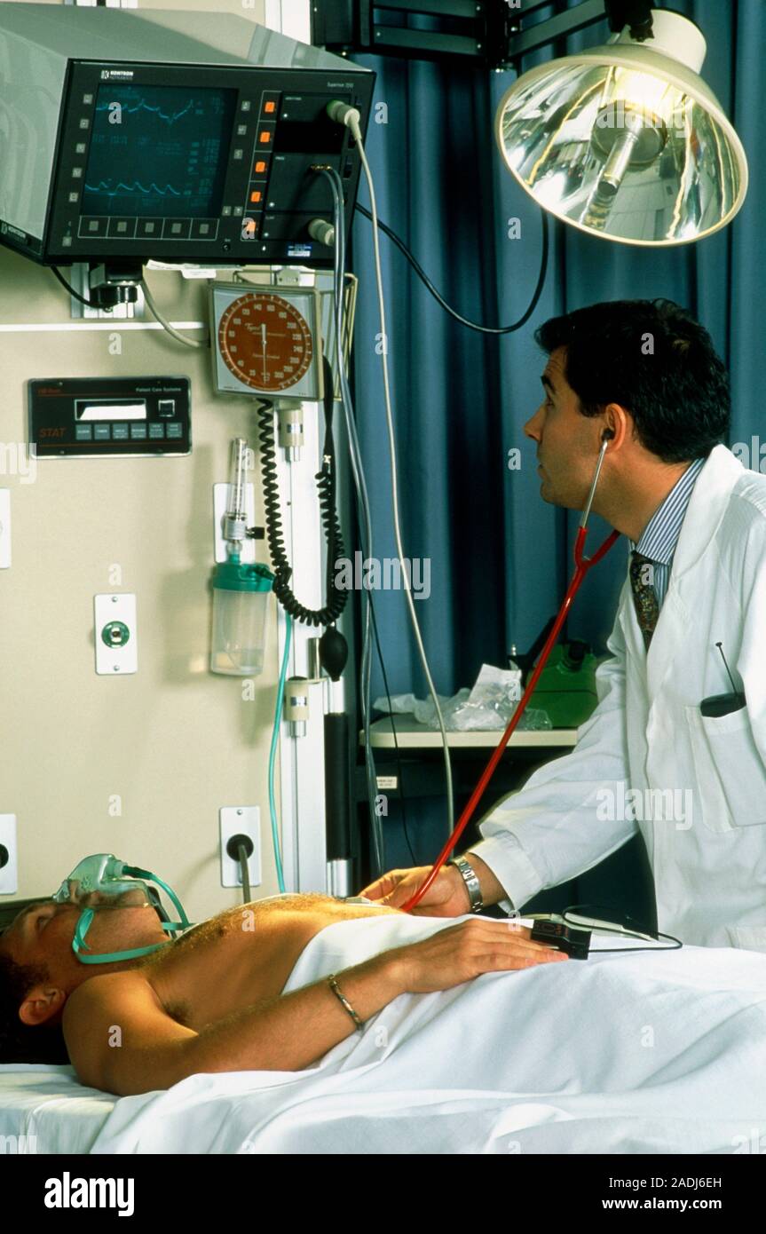 Intensive care unit. Doctor uses a stethoscope to check the heartbeat ...