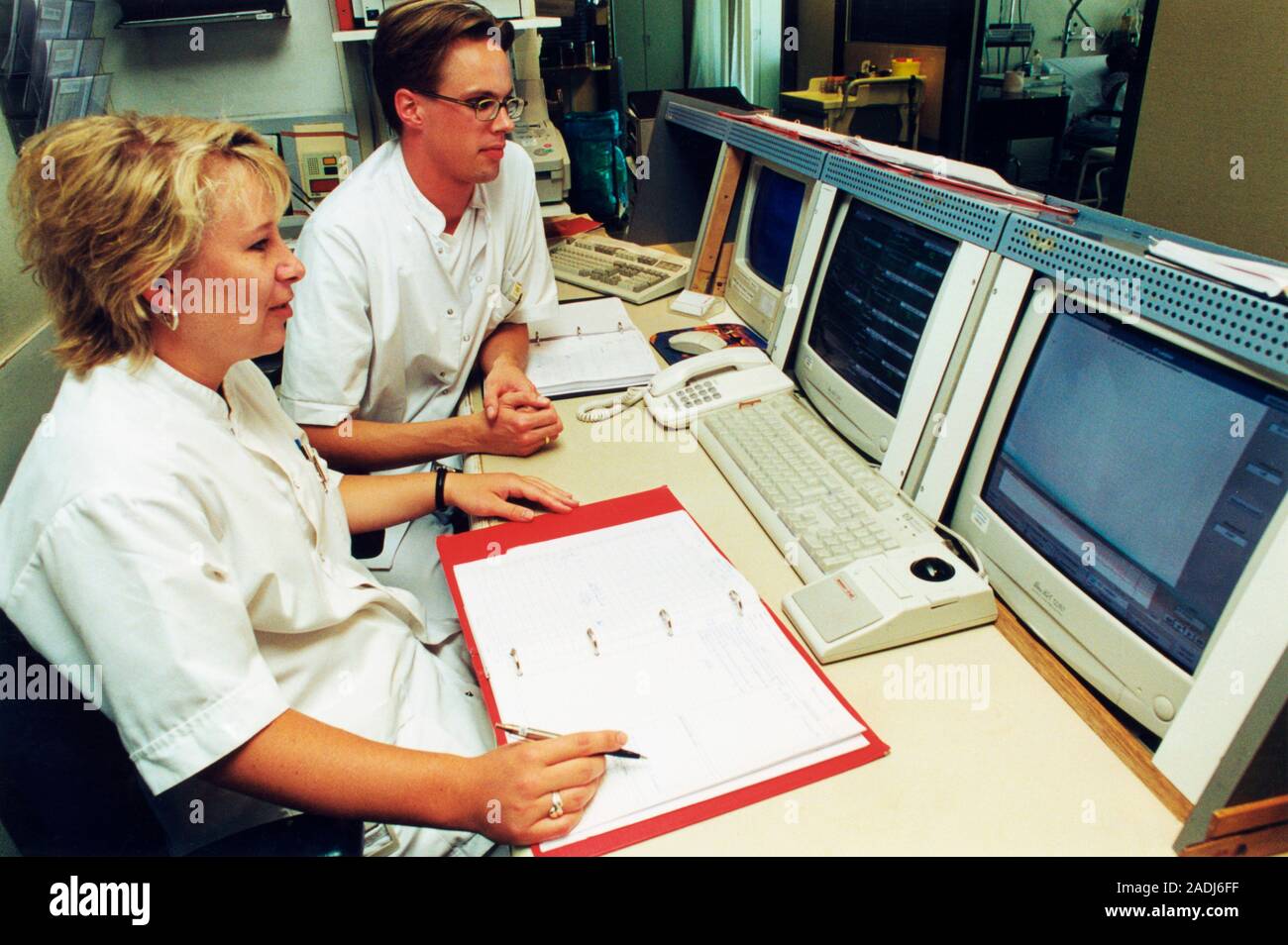Coronary care unit (CCU). Medical workers monitoring electrocardiogram ...