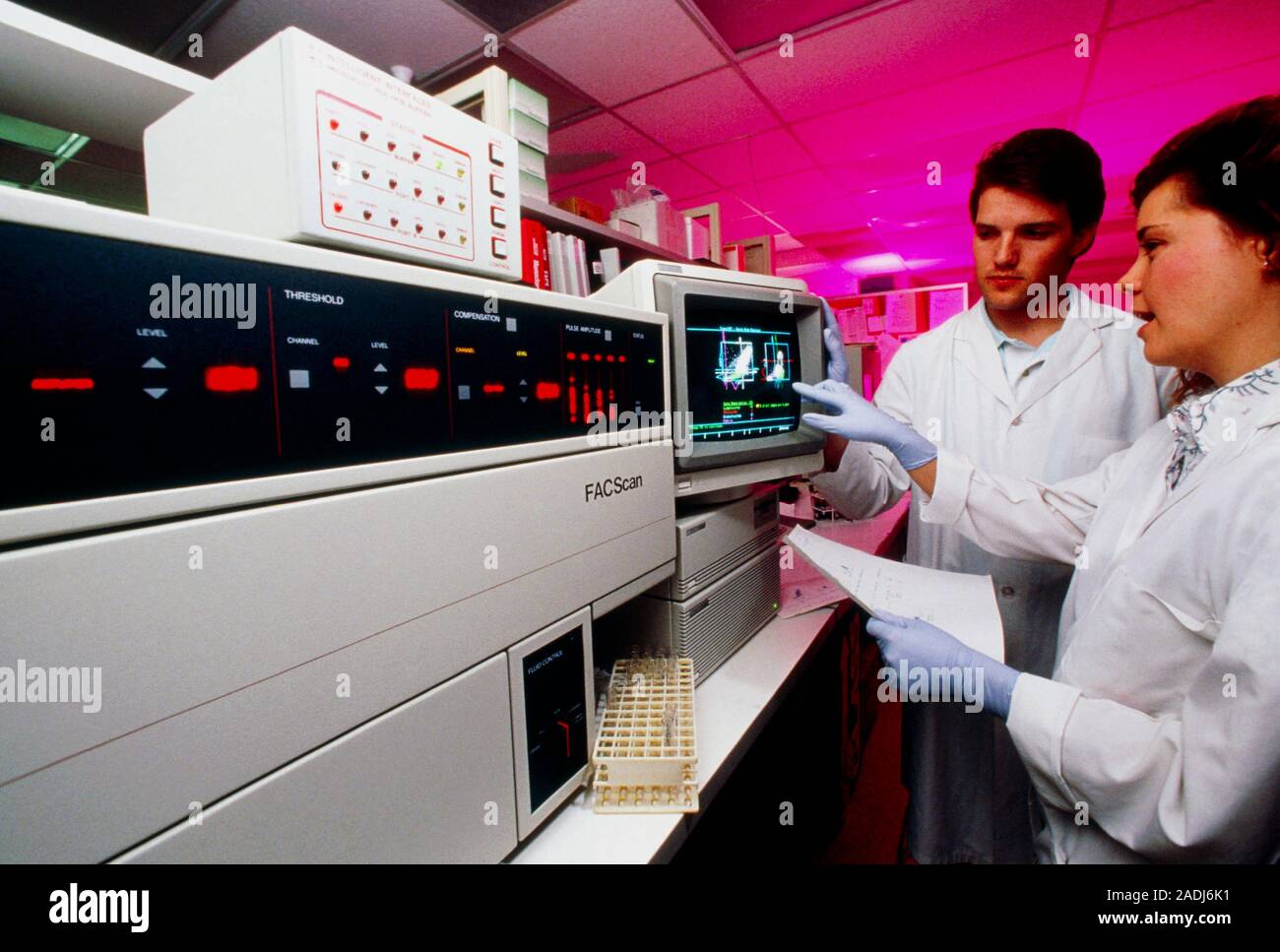 Flow cytometer. Technicians use a flow cytometer to analyse a sample of ...