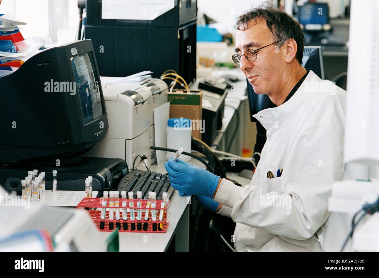 MODEL RELEASED. Pathologist in his lab analysing blood sample Stock ...