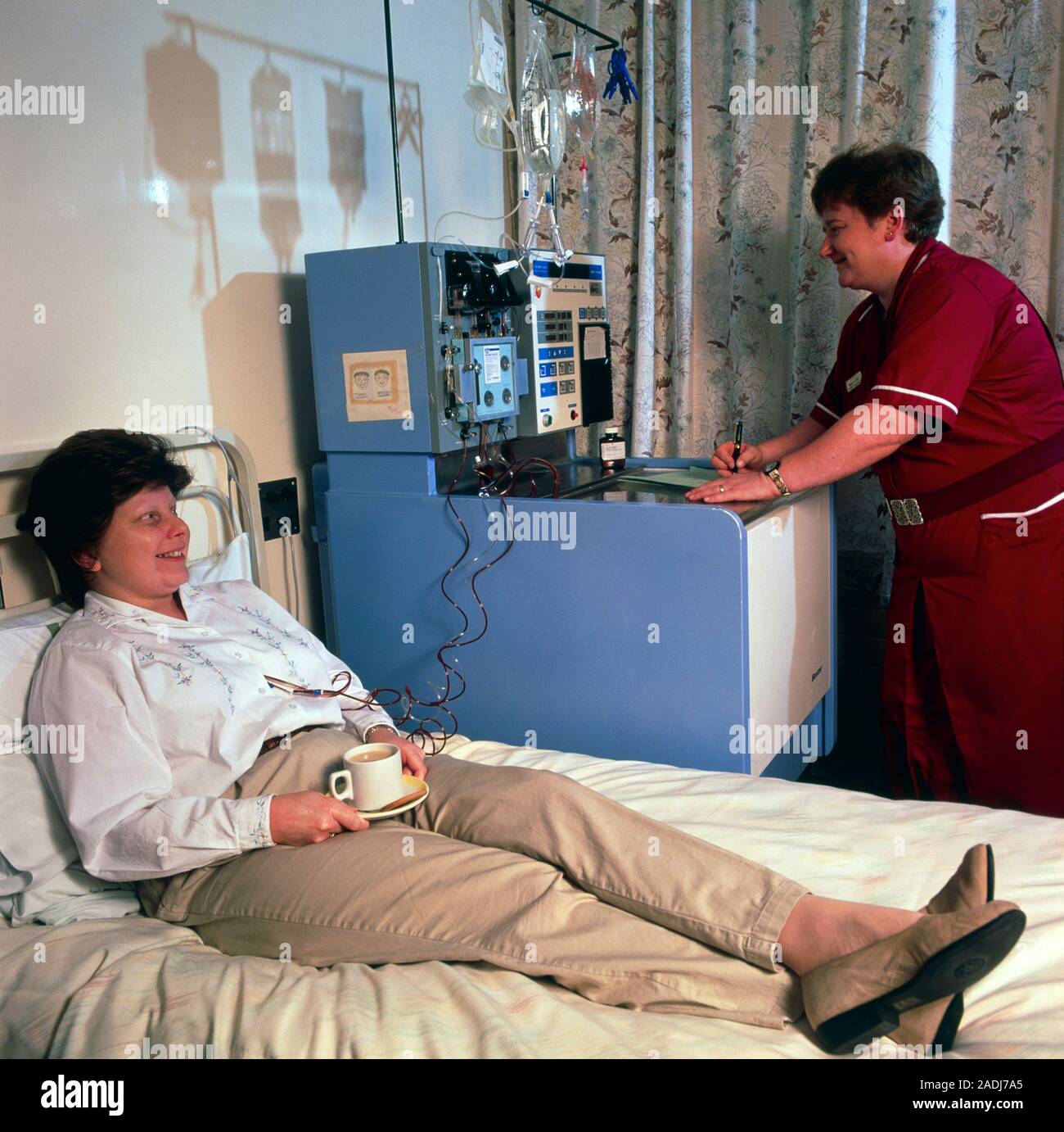 Blood stem cell harvesting. Woman attached to a blood cell separating ...