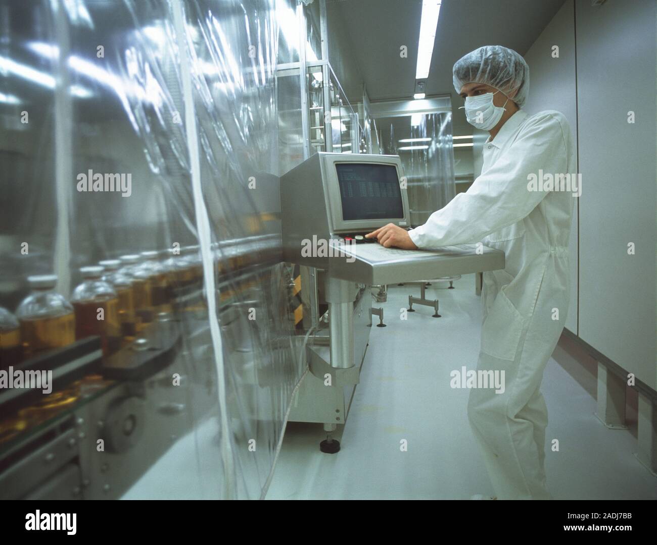Blood processing. Technician supervising an automatic production line ...