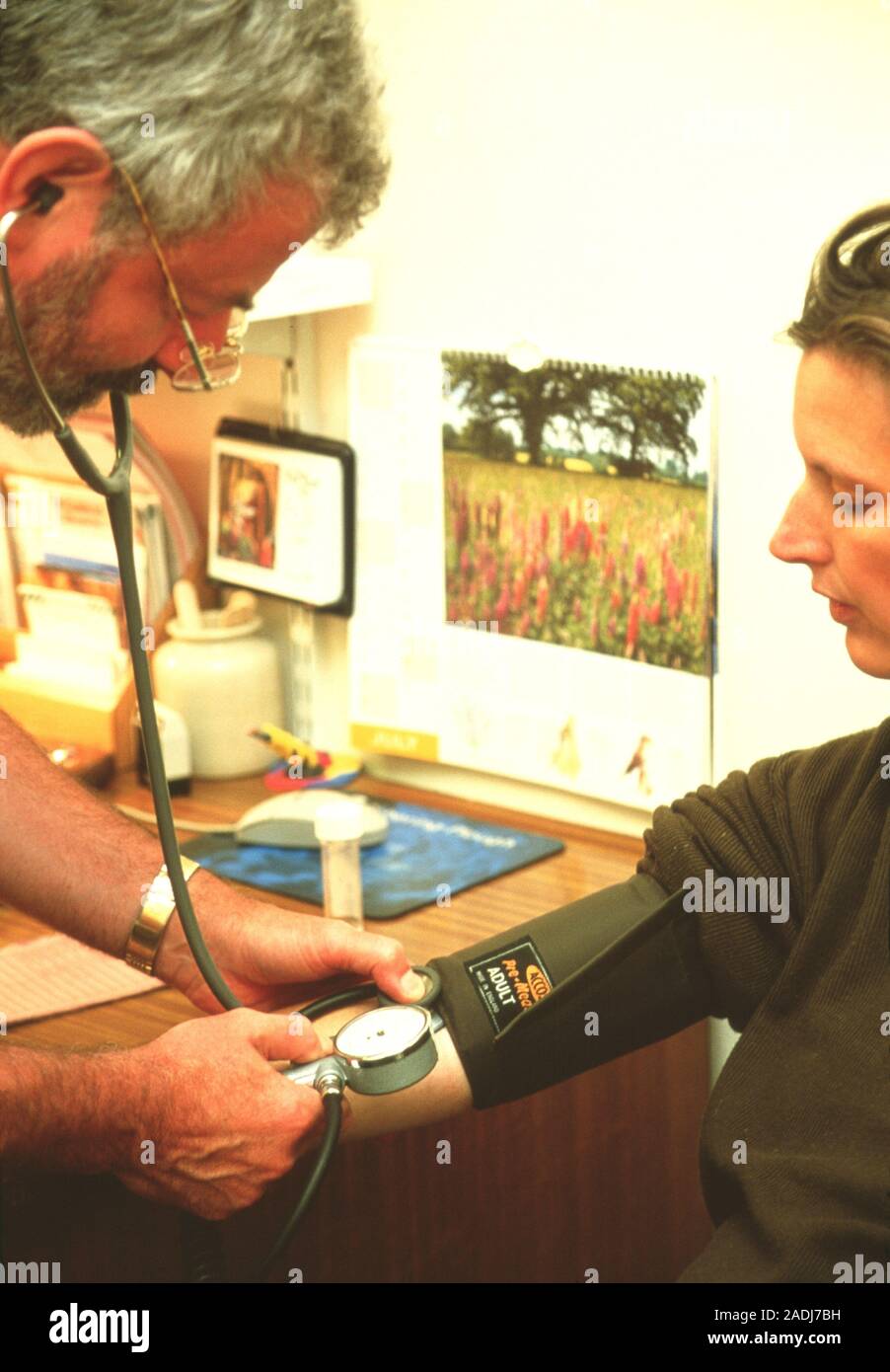 Measuring blood pressure. General practice (GP) doctor using a ...