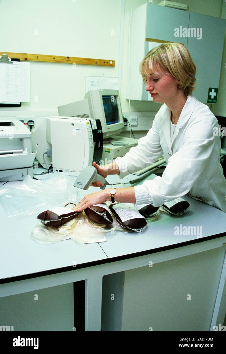 Registering blood bags. Laboratory technician using a barcode scanner ...