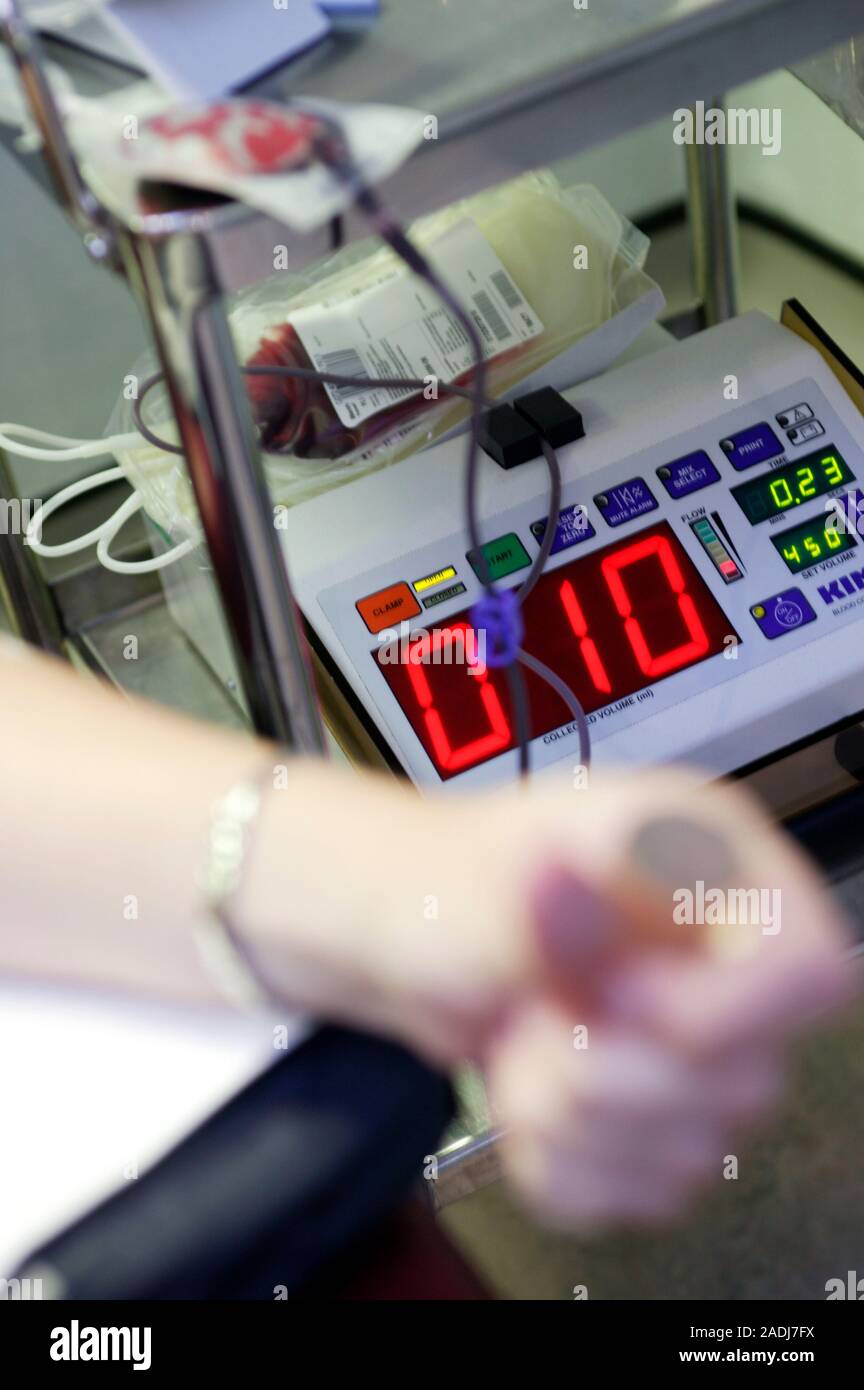 Blood donation. Blood bag on a weighing scale. As blood is collected ...
