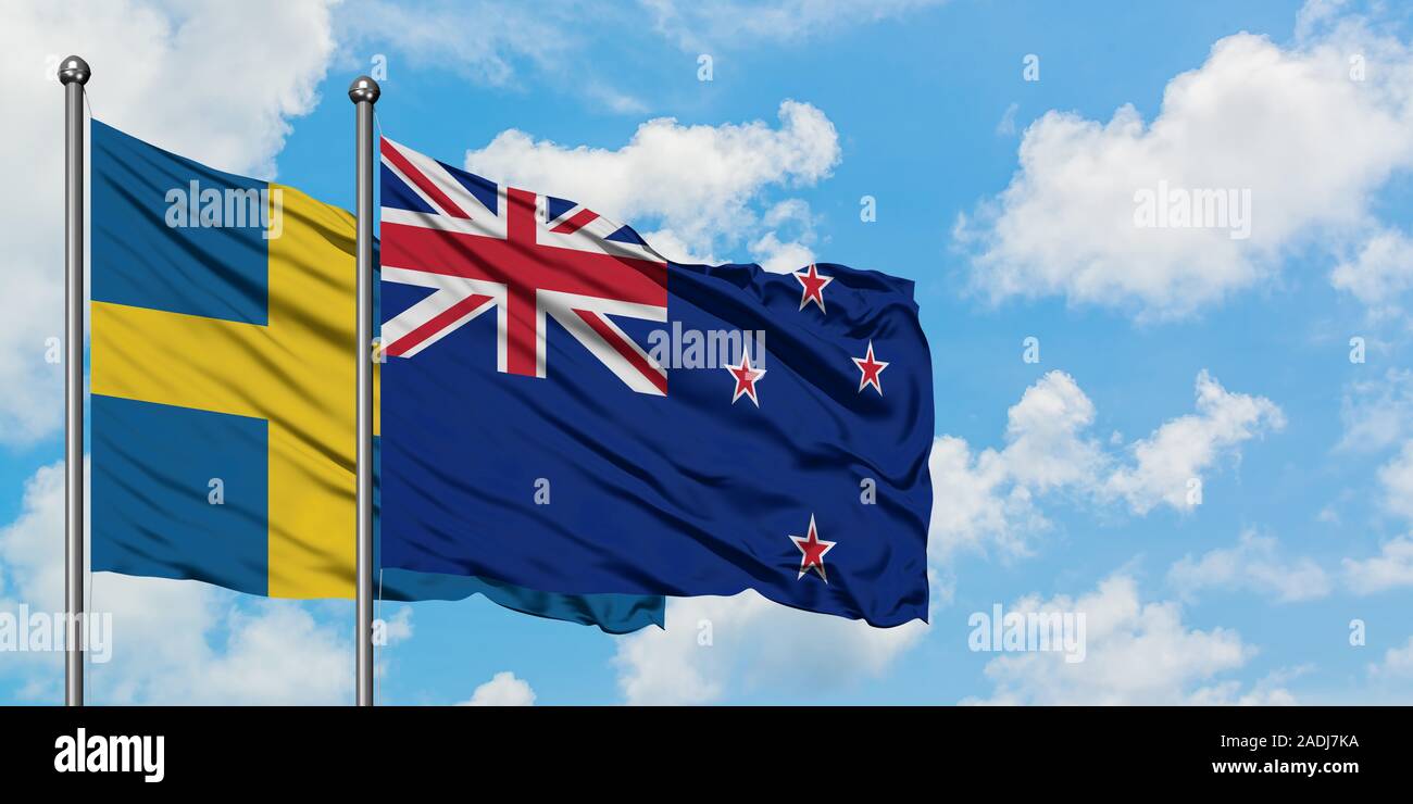 Sweden and New Zealand flag waving in the wind against white cloudy ...