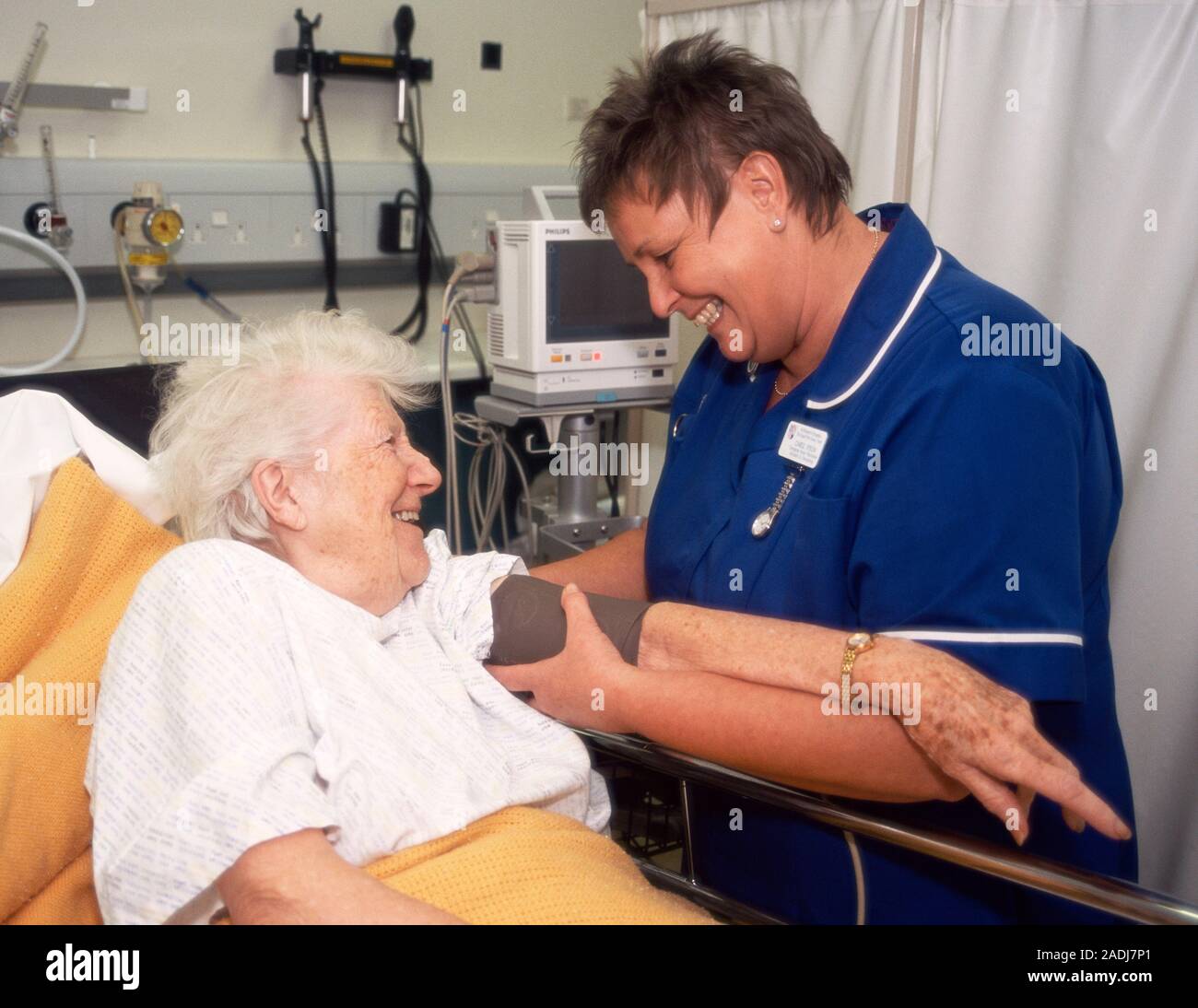 Measuring blood pressure. Hospital nurse measuring the blood pressure ...