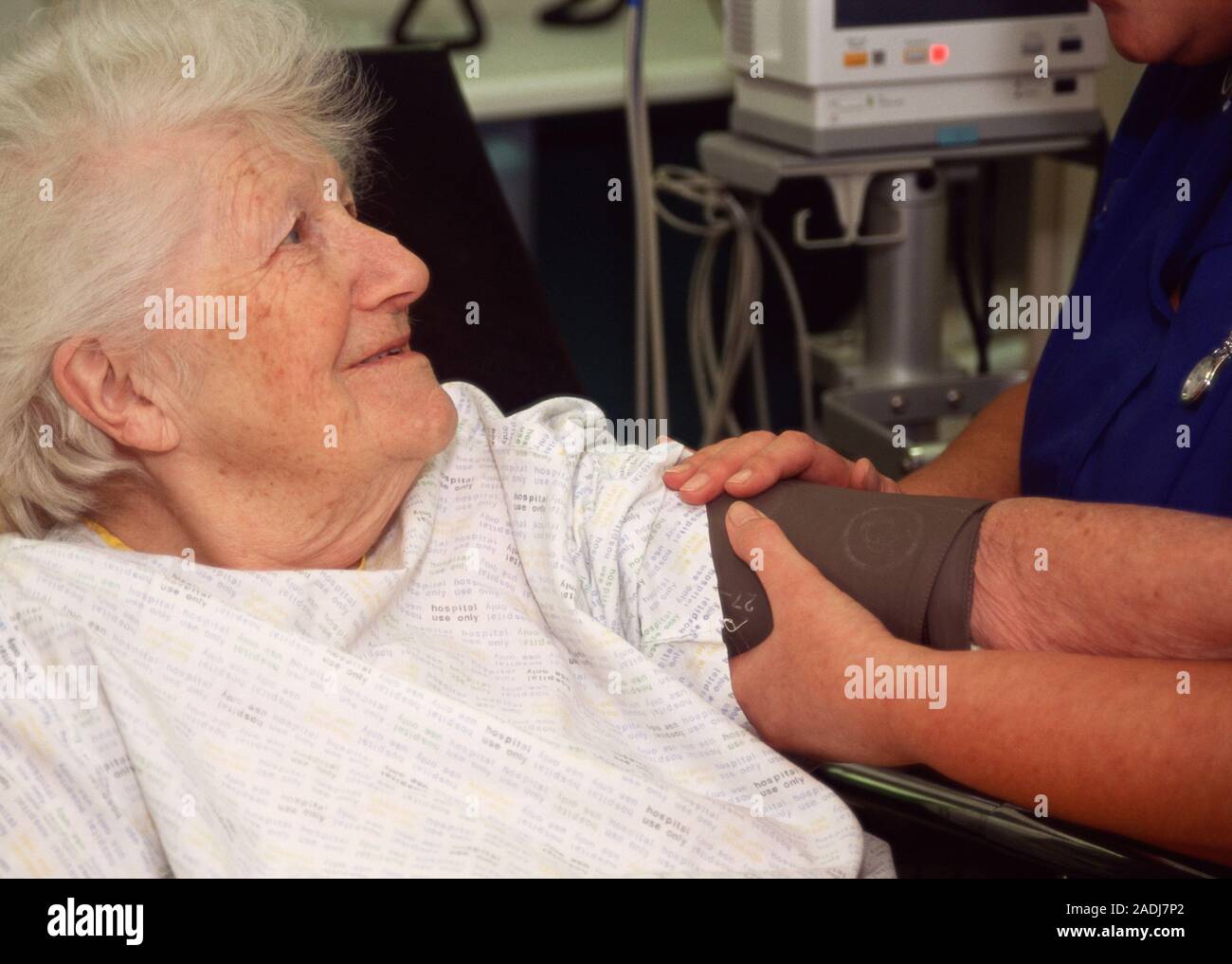 Measuring blood pressure. Hospital nurse measuring the blood pressure ...