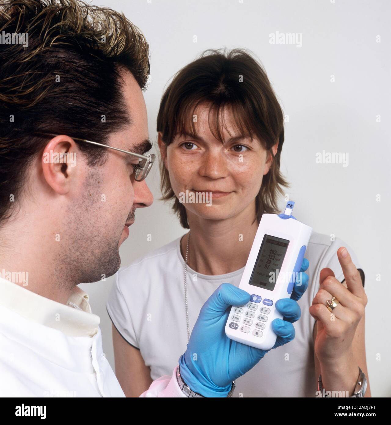 Blood cholesterol test. Medical worker holding a blood cholesterol ...