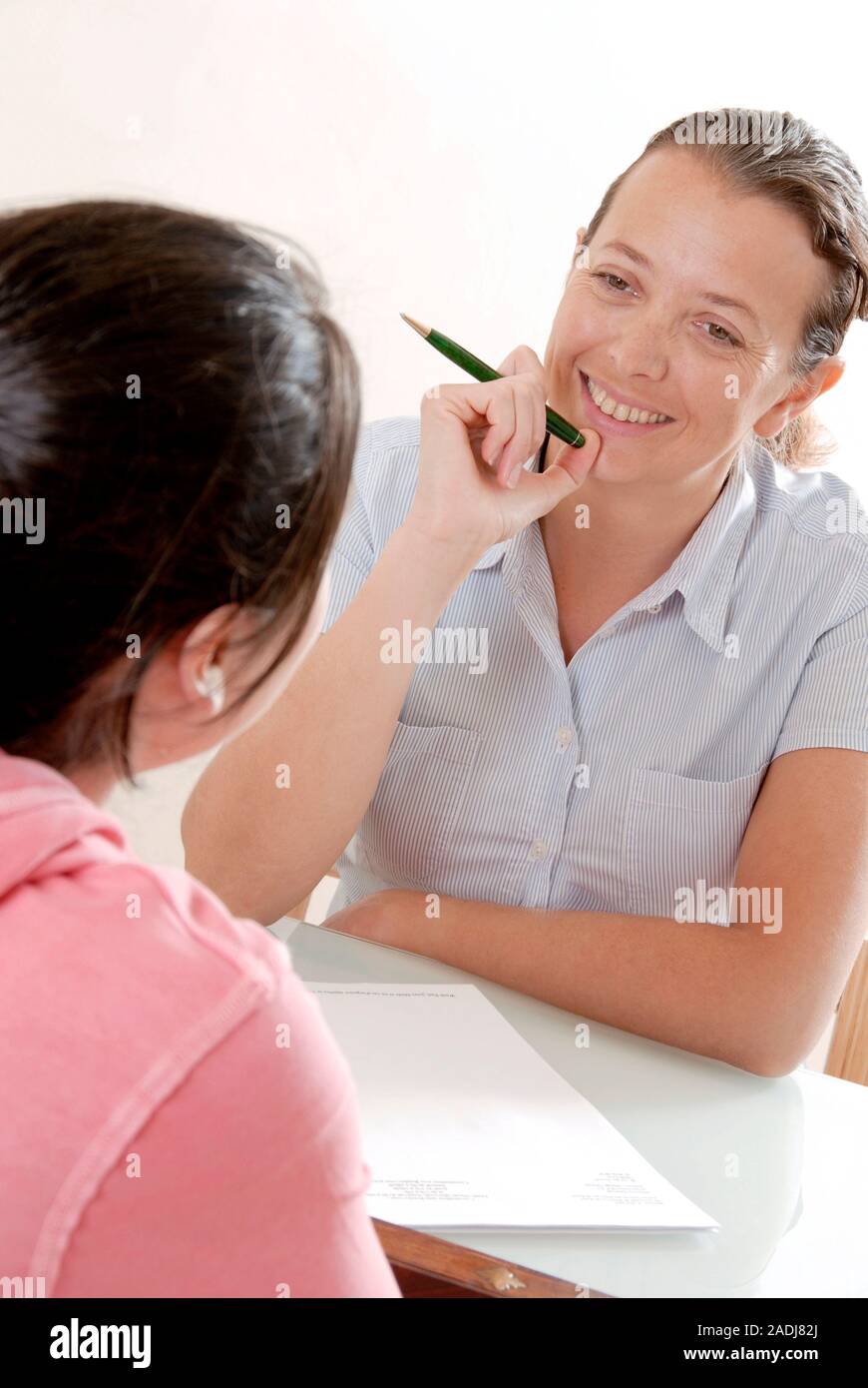 MODEL RELEASED. Counselling. Counsellor and client chatting together ...