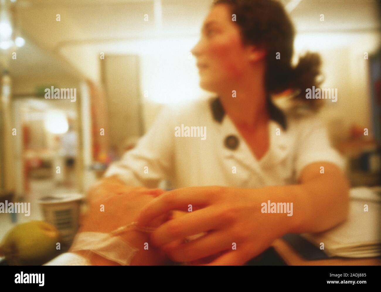 Ward rounds. Blurred view of a nurse at work in a hospital ward as seen ...