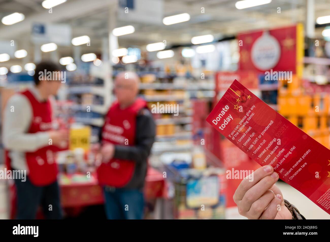 A donation leaflet in front of volunteers at the Tesco supermarket ...