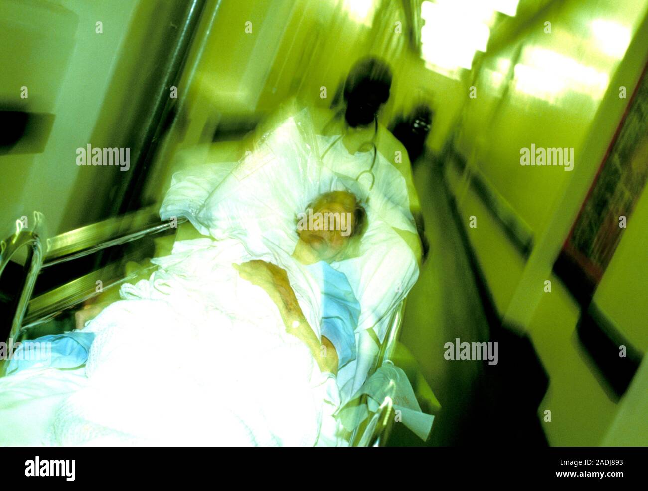 Patient transport. Blurred view of a medical worker moving a bed-bound ...