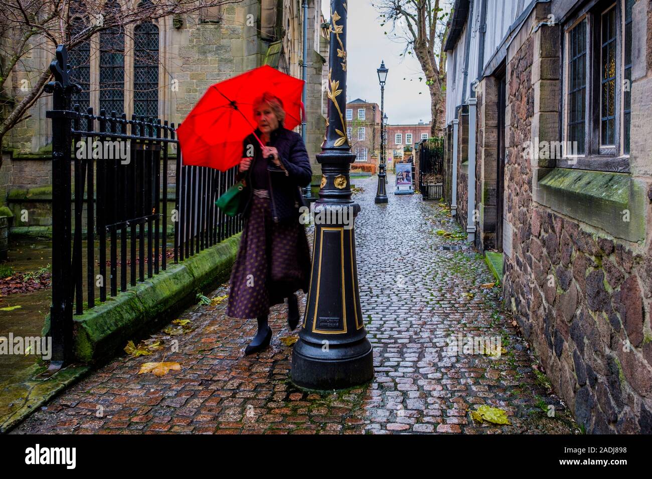 Woman walking red umbrella hi-res stock photography and images - Alamy