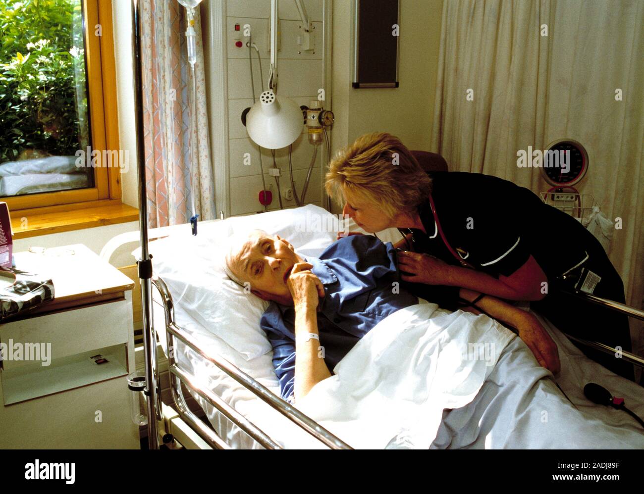 Nurse & elderly patient. Hospital nurse reassuring an elderly patient ...