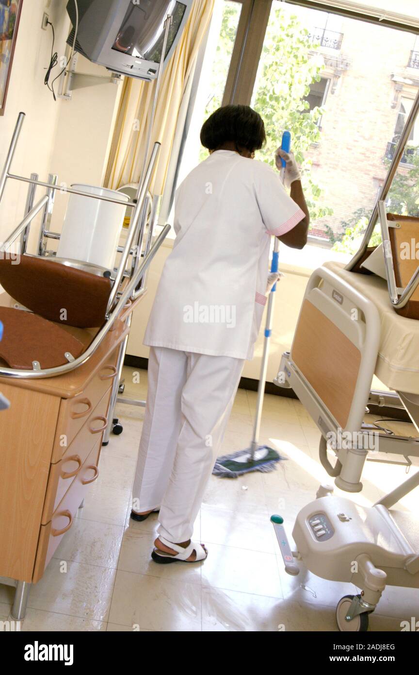 Cleaning hospital room. Hospital cleaner using a mop to clean and ...