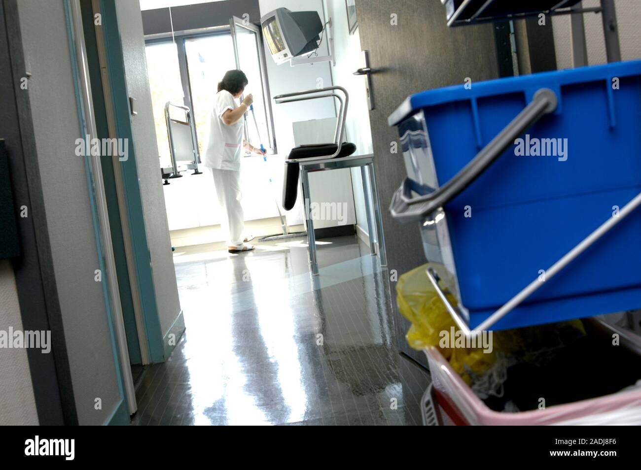 Cleaning hospital room. Hospital cleaner using a mop to clean and ...