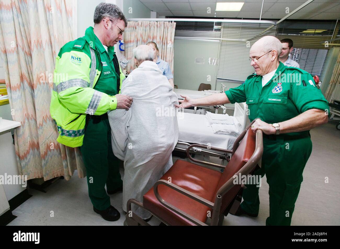 MODEL RELEASED. Patient hand-over. Paramedic and ambulance technician ...