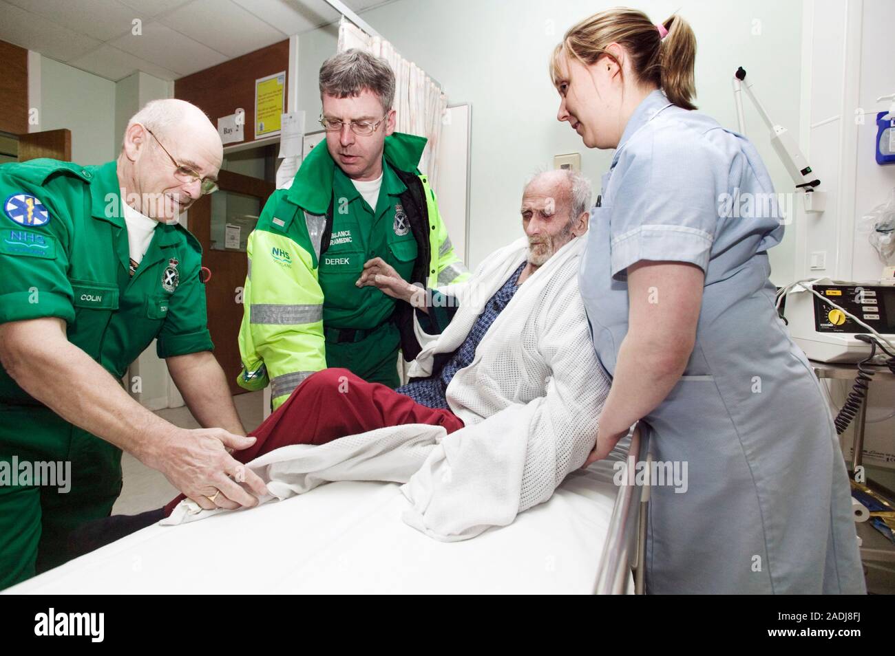 MODEL RELEASED. Patient hand-over. Paramedic, ambulance technician and ...