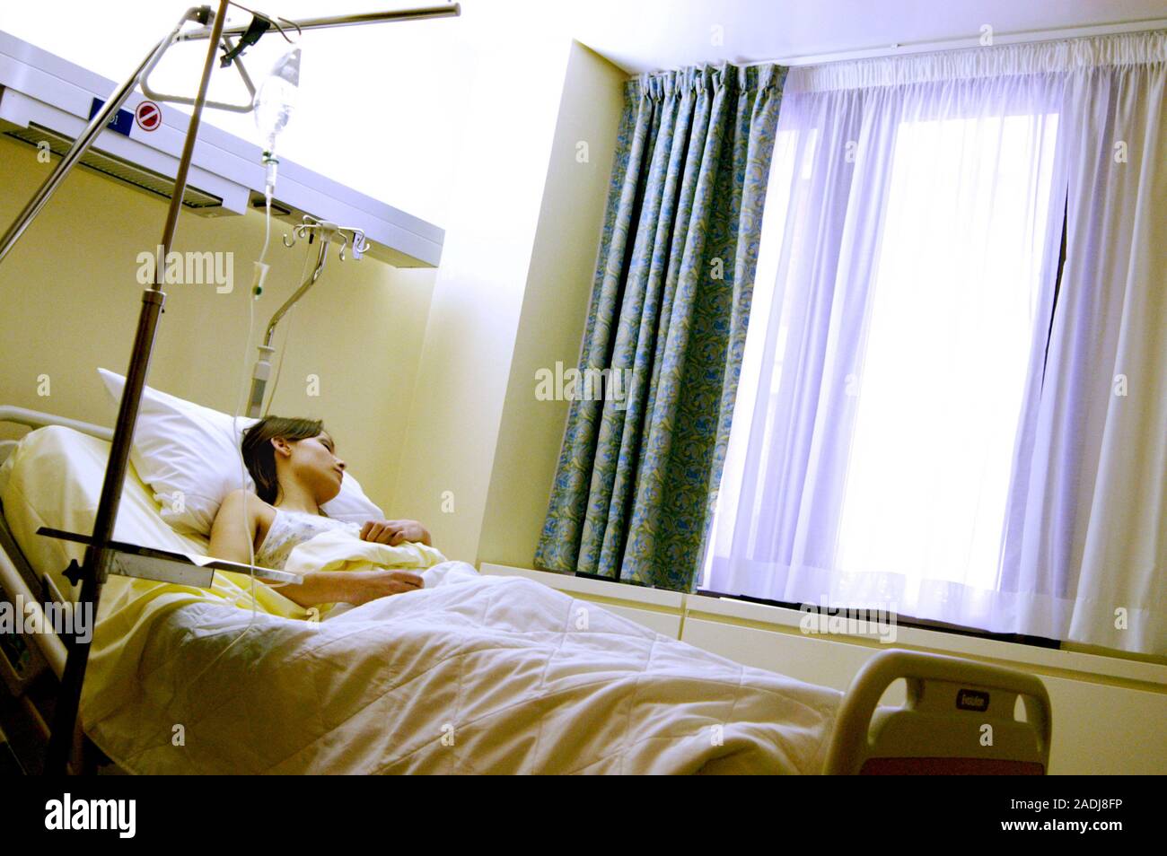 MODEL RELEASED. Patient on a ward. Patient connected to an intravenous ...