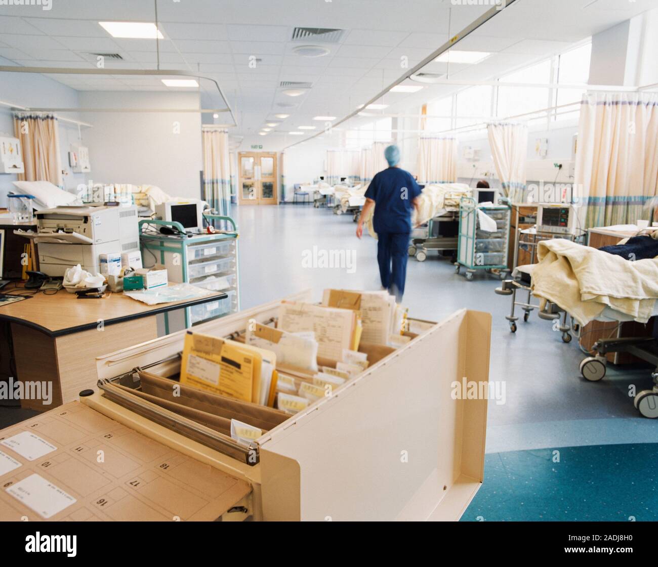 MODEL RELEASED. Hospital ward. Health professional walking through a ...