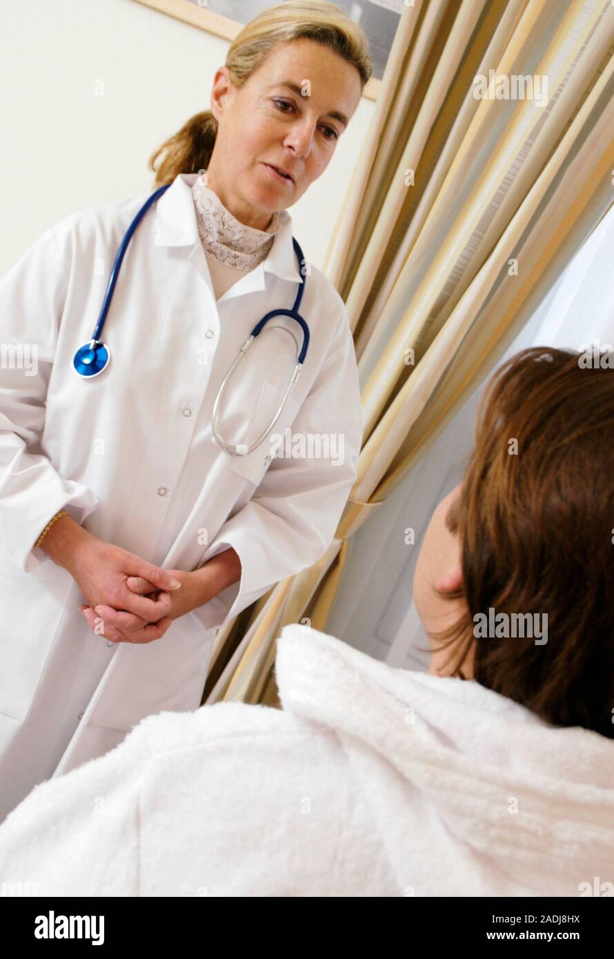 MODEL RELEASED. Doctor and patient talking during a ward visit Stock ...