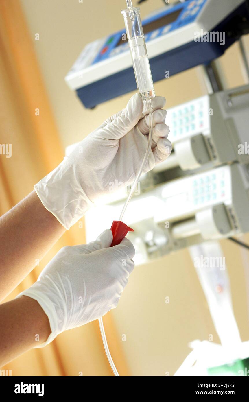 Intravenous drip. Image 2 of 4. Nurse adjusting the settings on an ...