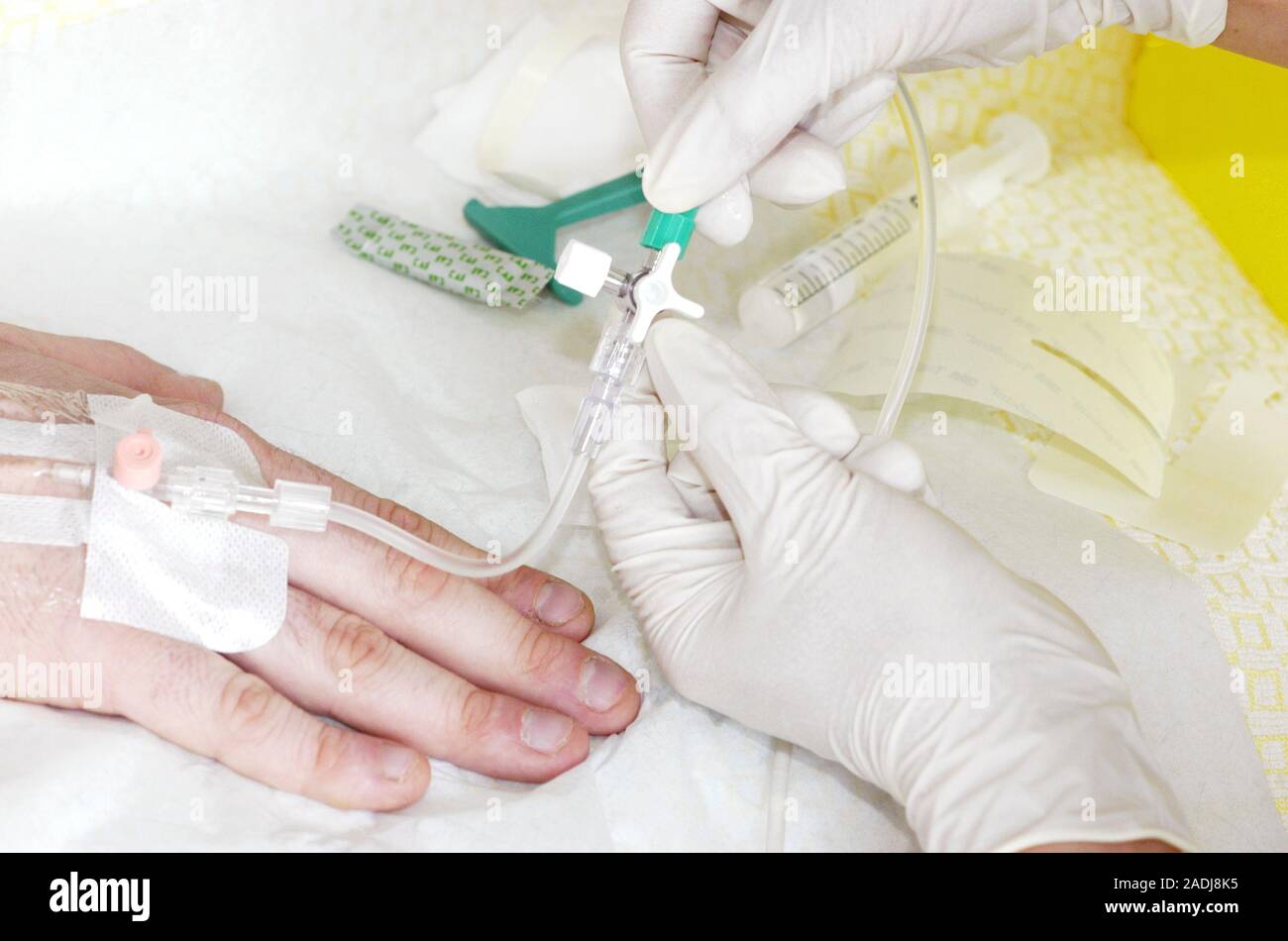 Intravenous drip. Image 3 of 4. Nurse adjusting the settings on an ...