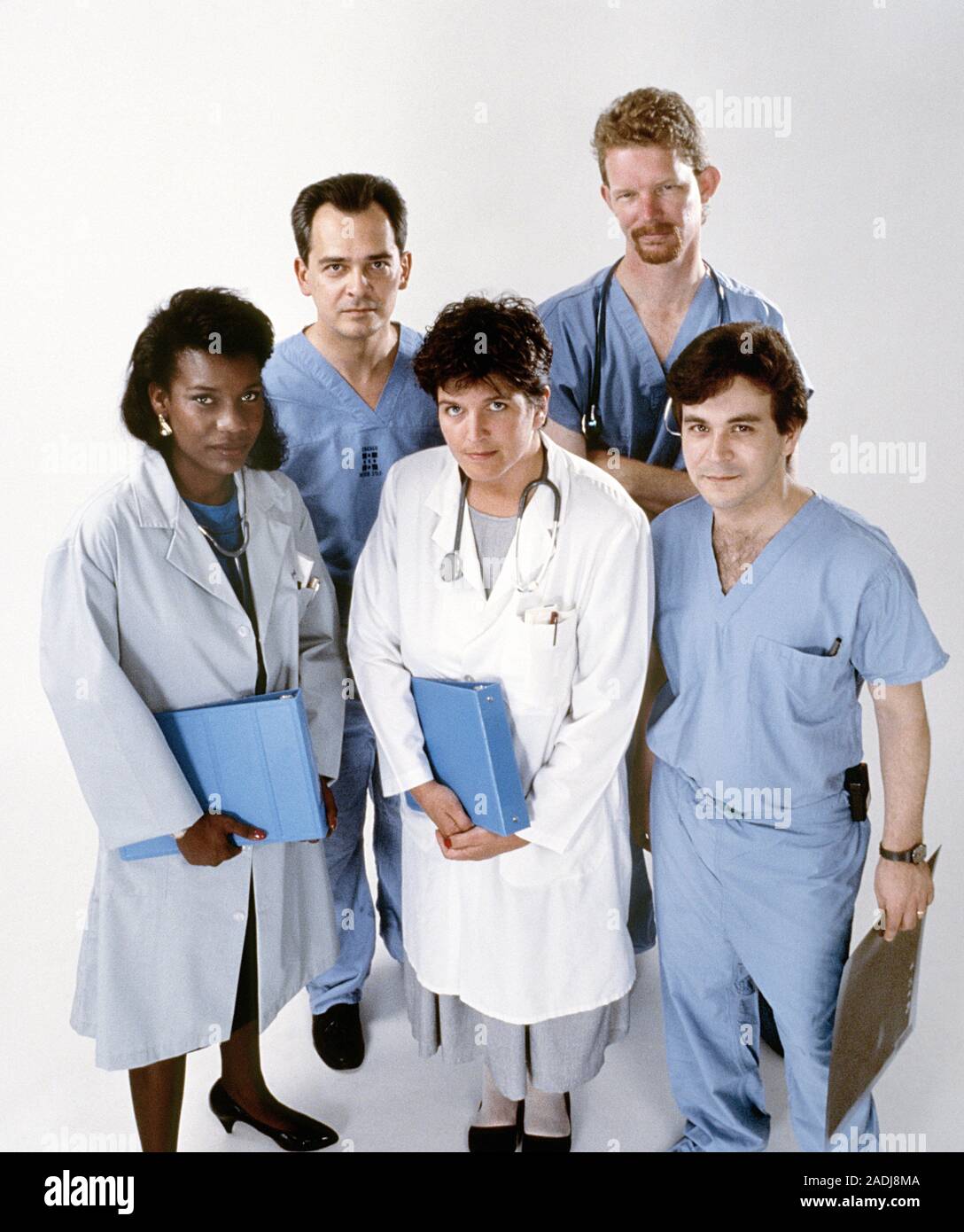 Hospital staff. Portrait of a group of five hospital staff, including ...