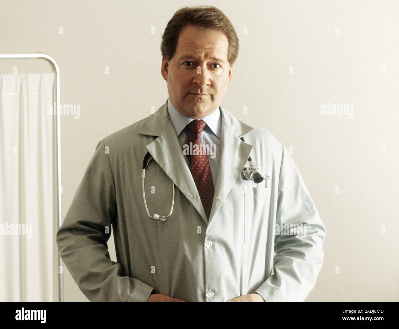 Doctor. Portrait of a male medical doctor standing in his surgery Stock ...