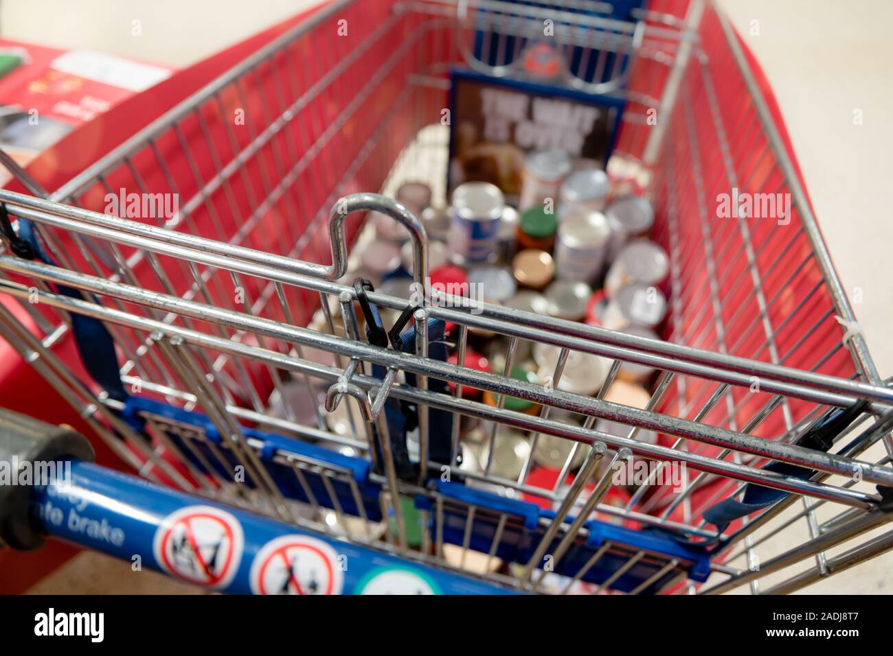 A shopping trolley with donated tins at the national food bank ...